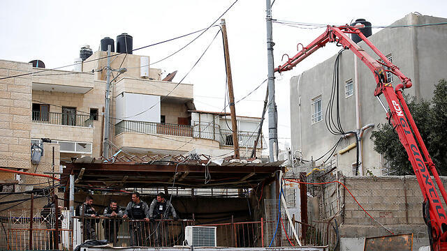 Victim's parents watch terrorist's home sealed off