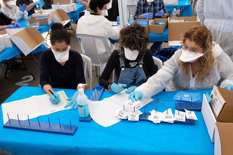 Masked election monitors count coronavirus votes, carefully